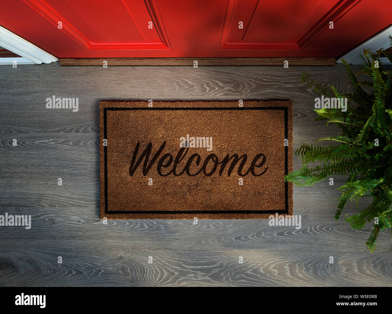 Overhead view of welcome mat outside inviting front door of house with ...