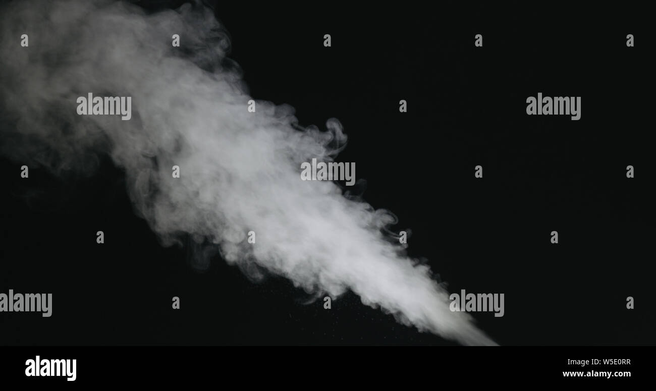 water vapor stream comes from below over black background with motion ...