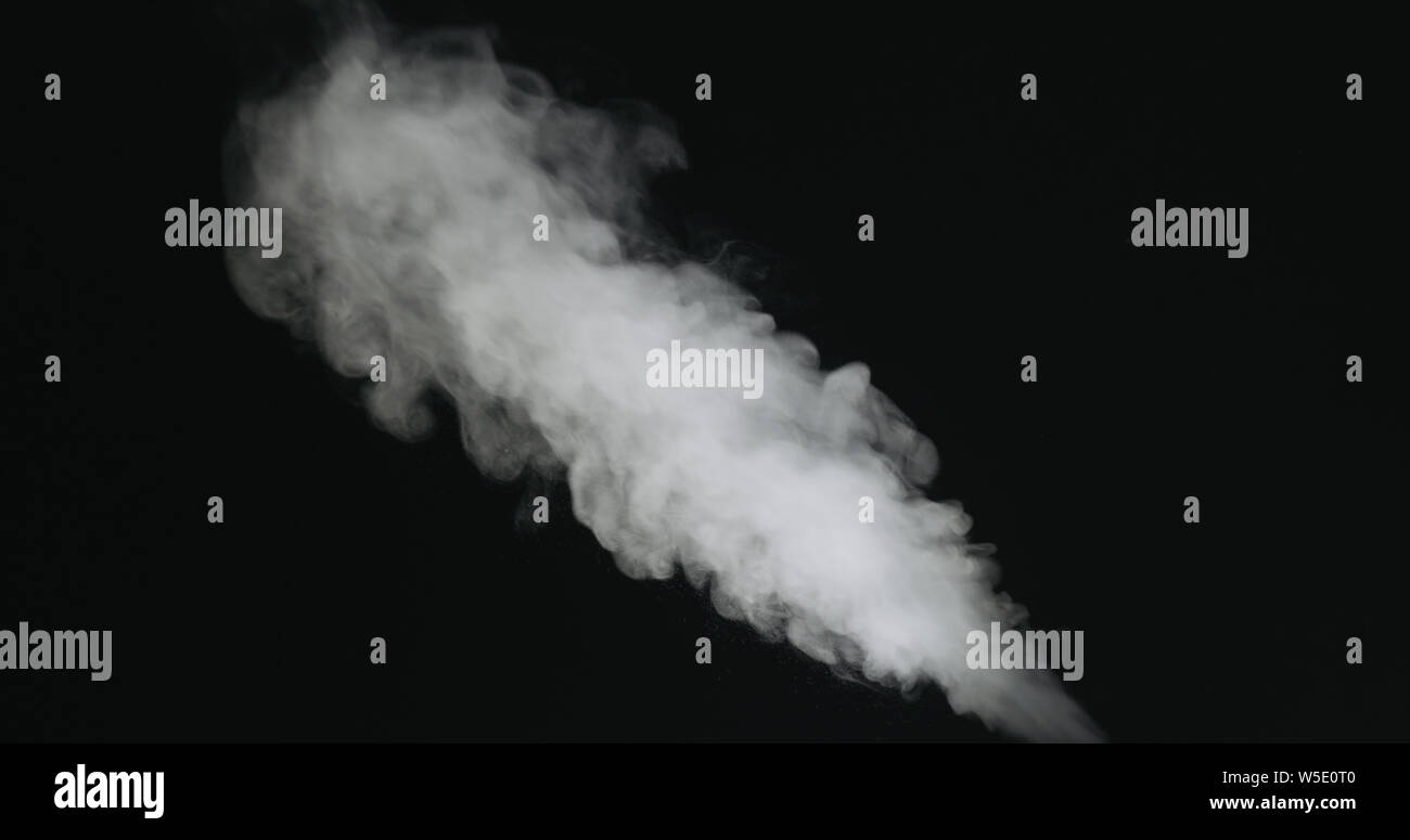 water vapor stream comes from below over black background with motion ...