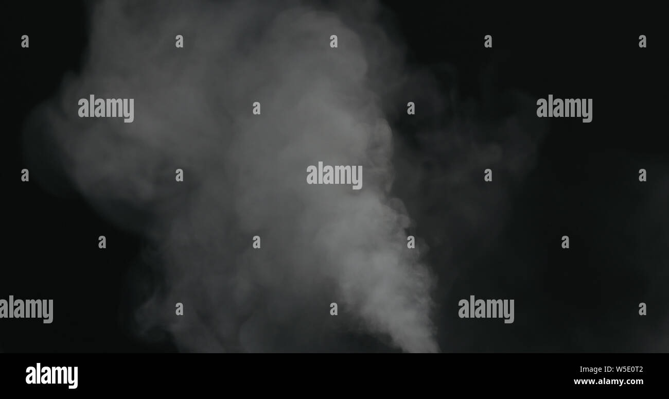 water vapor stream comes from below over black background with motion ...