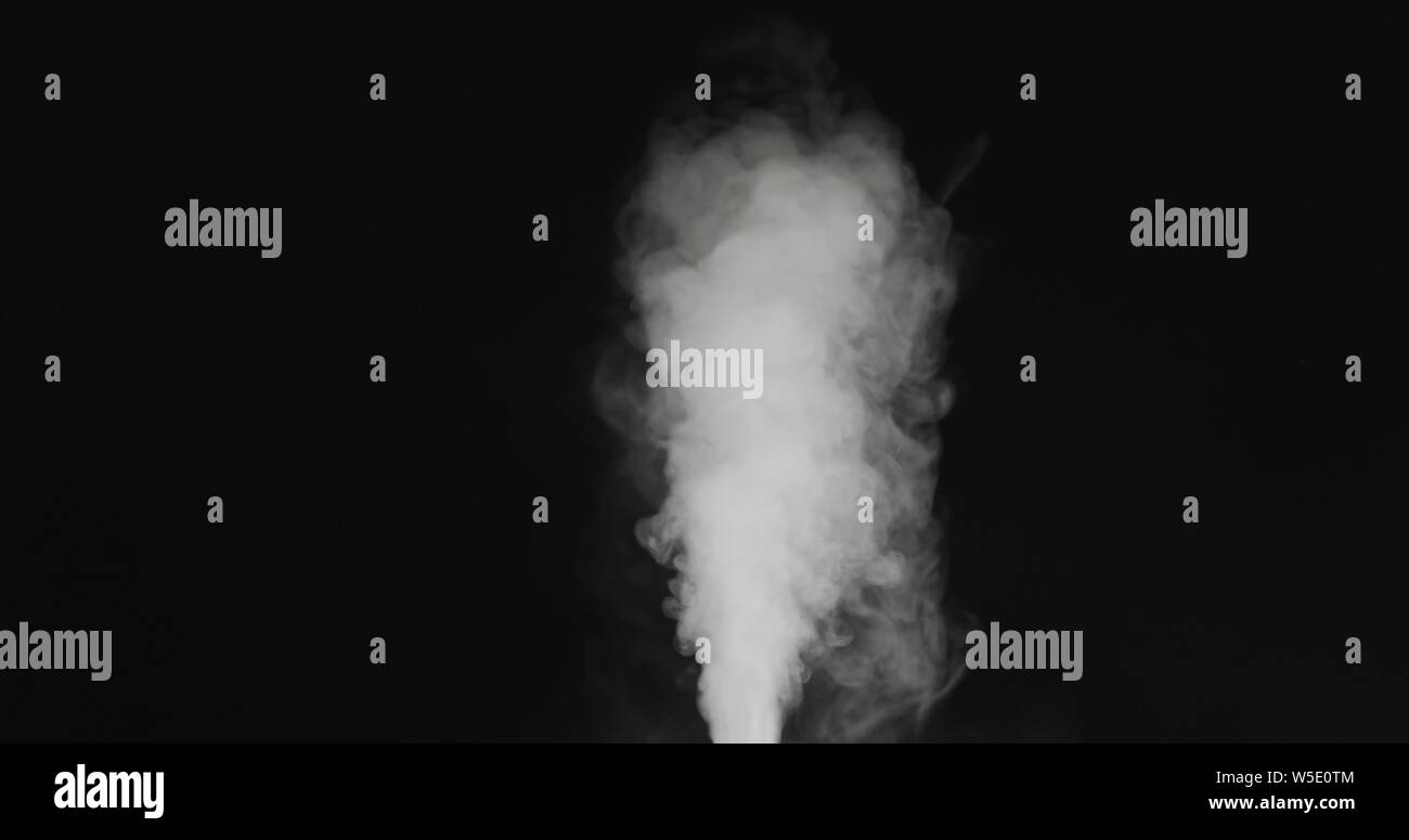 water vapor stream comes from below over black background with motion ...