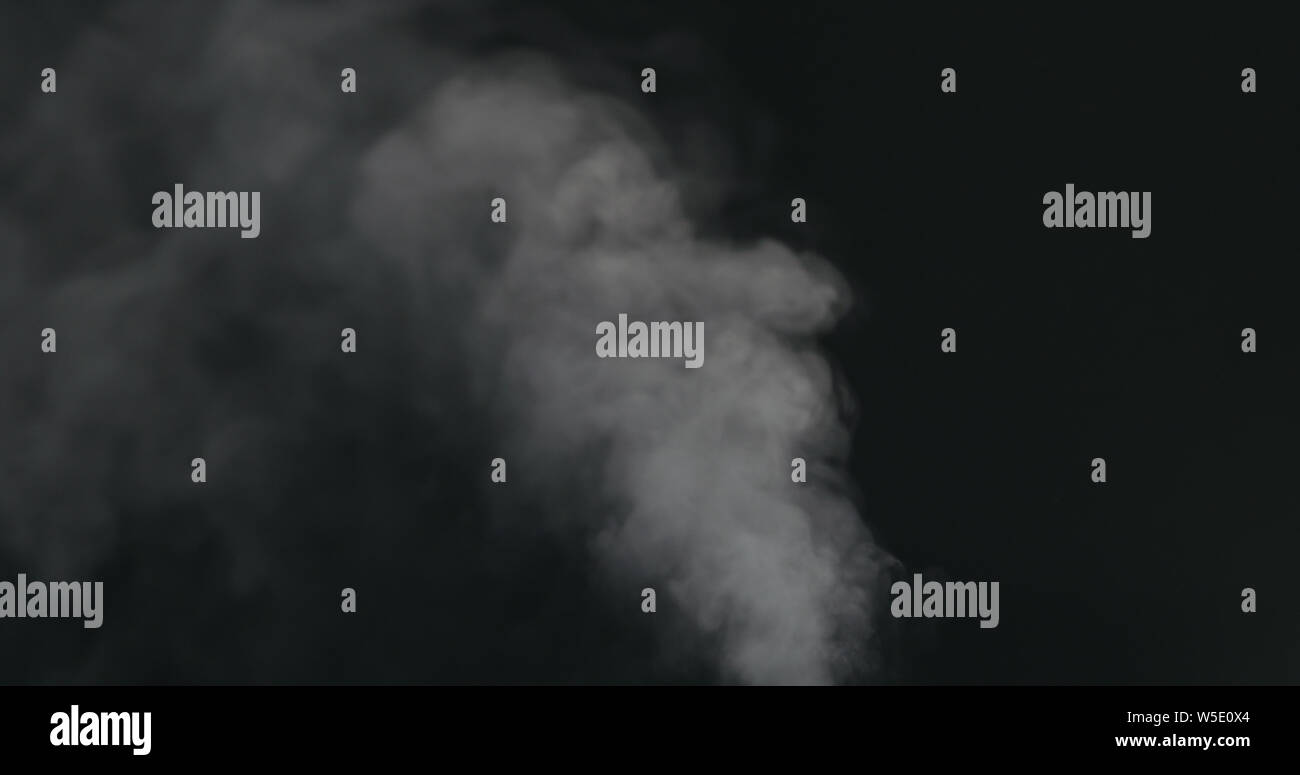 water vapor stream comes from below over black background with motion ...