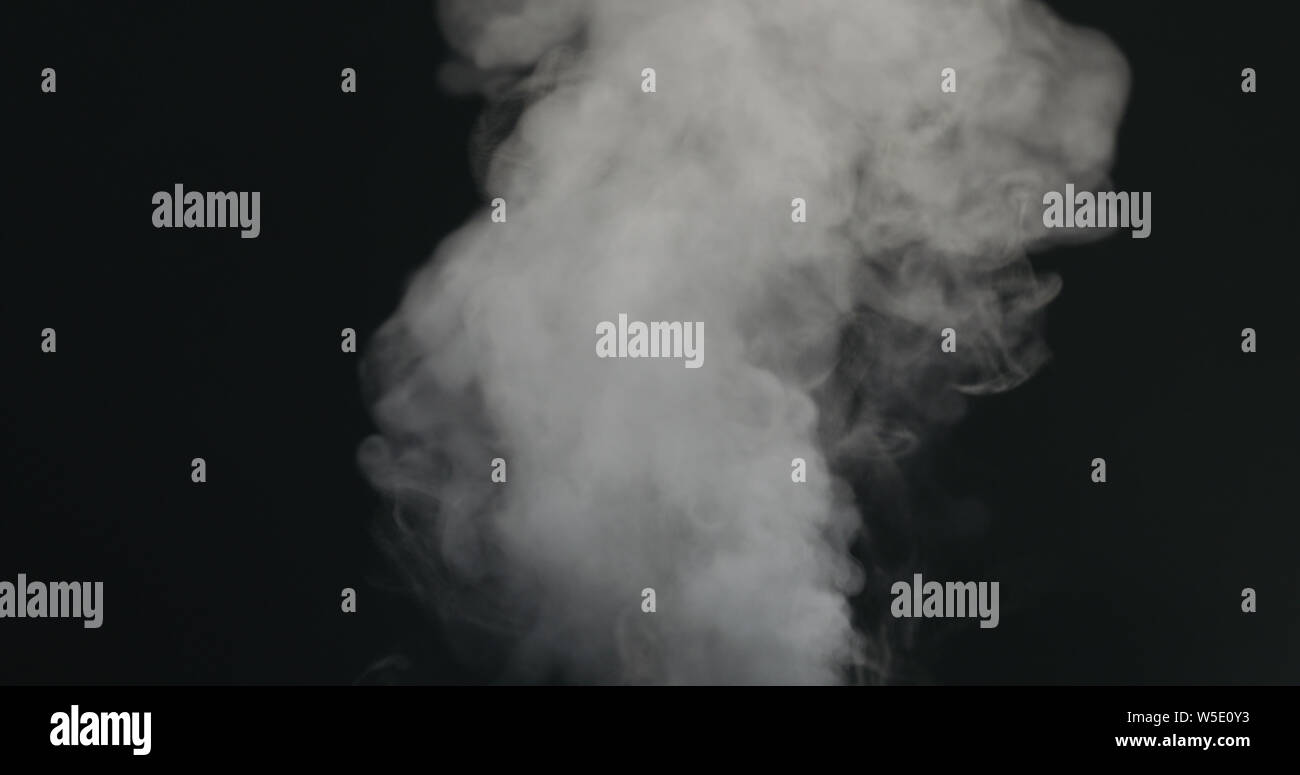 water vapor stream comes from below over black background with motion ...
