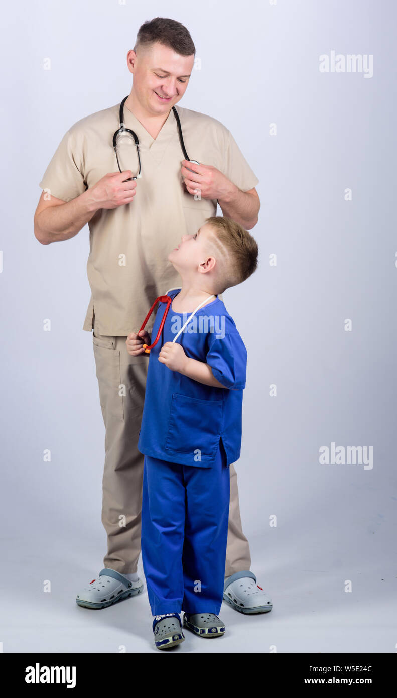 Want to be doctor as dad. Cute kid play doctor game. Family doctor ...