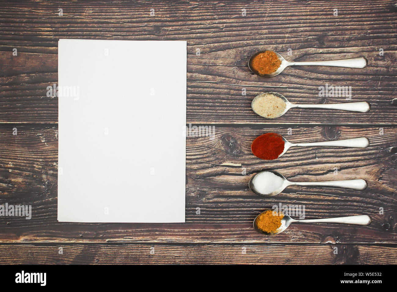 Spices in spoon and white paper for recipe Stock Photo - Alamy
