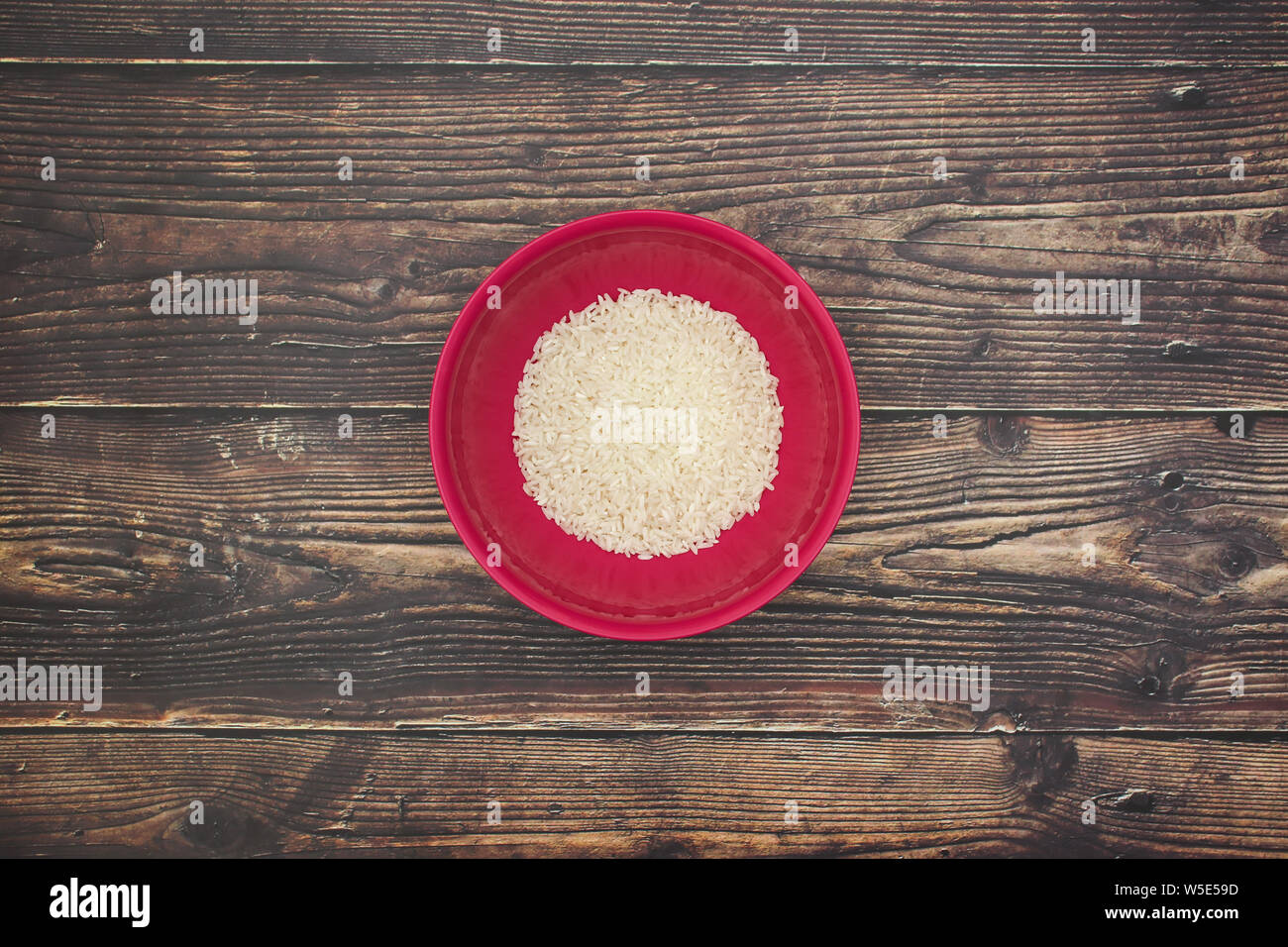 Raw pink rice in bowl hi-res stock photography and images - Alamy