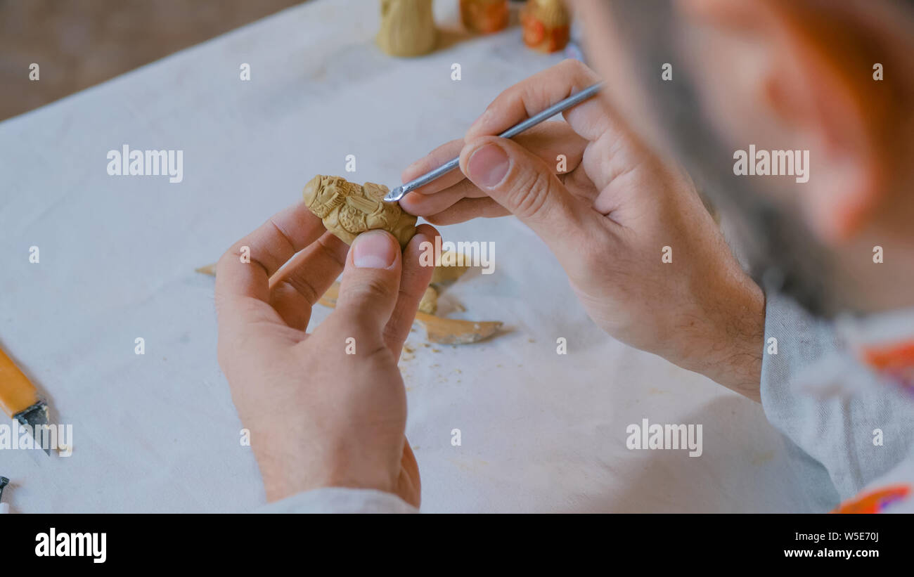 Potter making clay figure for board game Stock Photo - Alamy