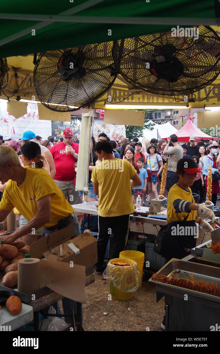 Food preparation at the spiral cut deep fried potato stall at the ...