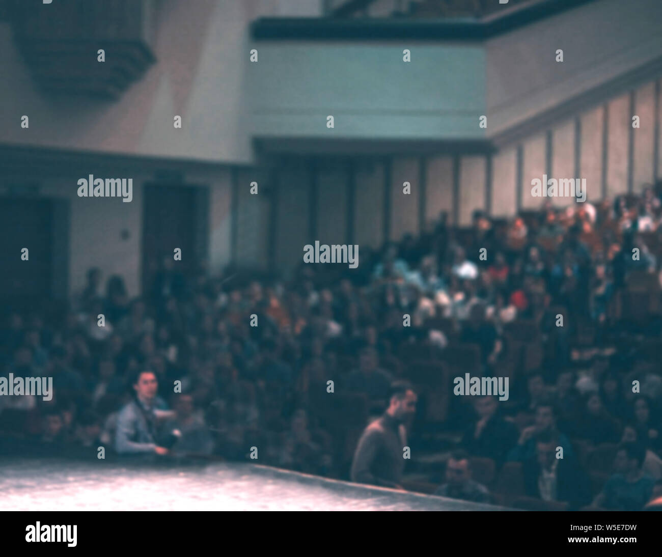blurred image of the audience and media representatives at a briefing ...