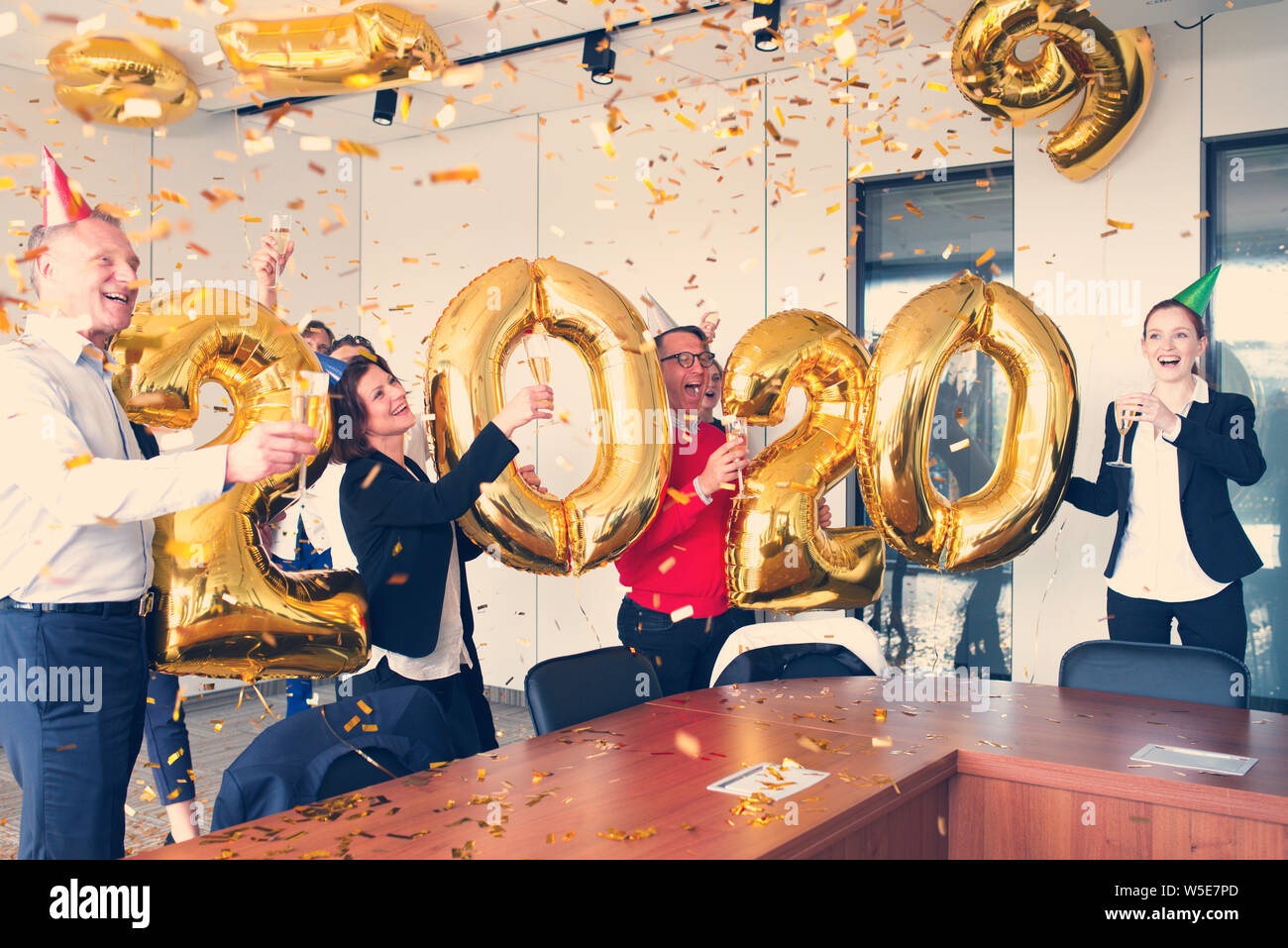 Business people celebrating 2020 New Year at office party Stock Photo ...