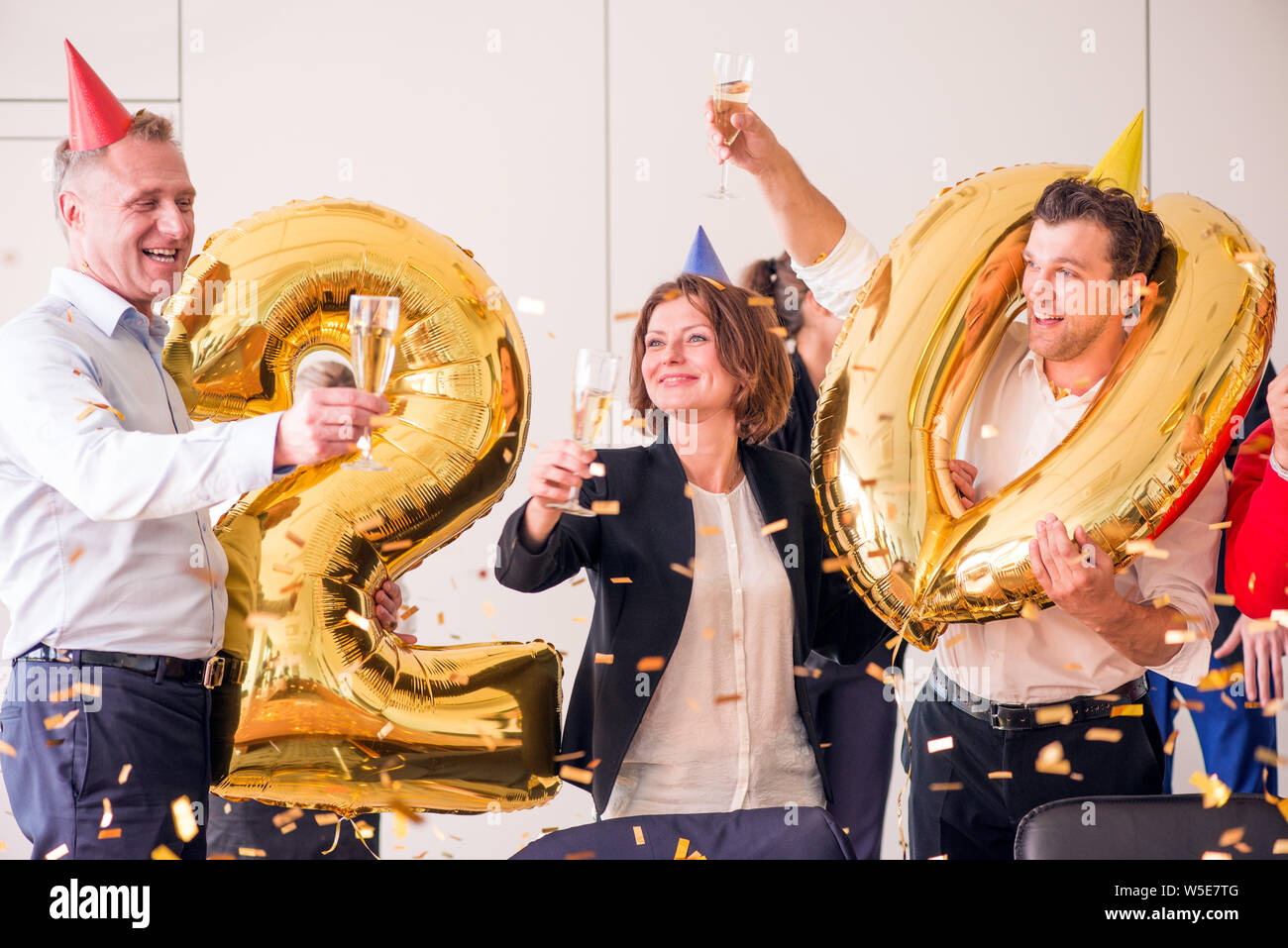 Business people celebrating 2020 New Year at office party Stock Photo ...