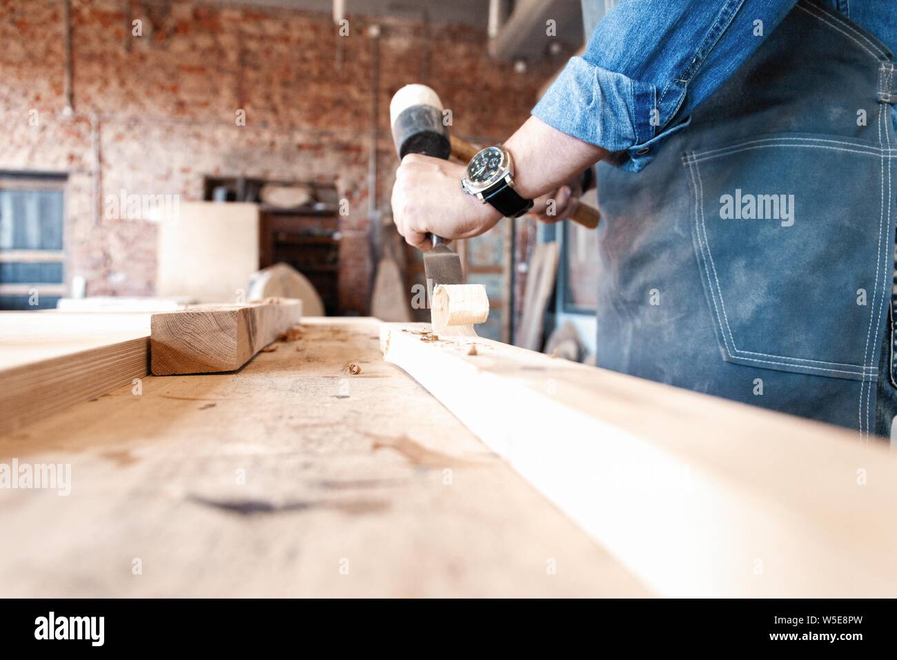 Carpenter working on woodworking machines in carpentry shop. A man ...