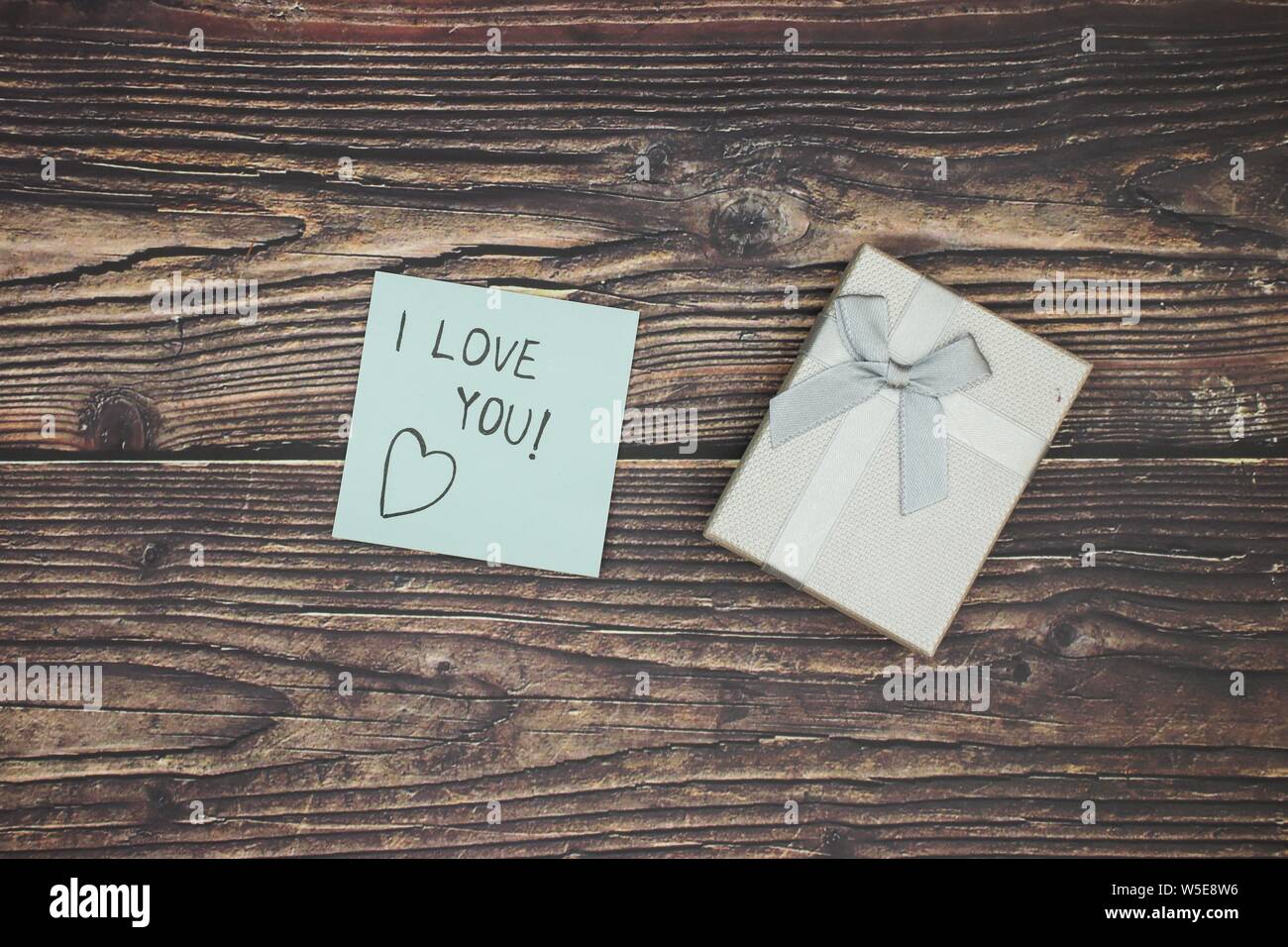 Silver present for happy birthday on wooden table Stock Photo - Alamy