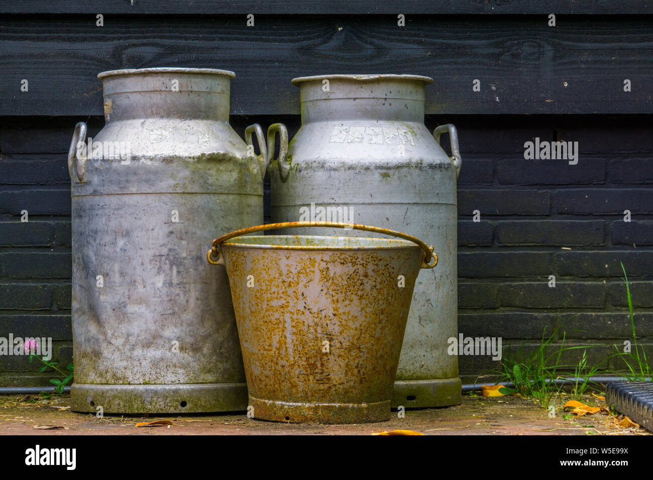 vintage farm equipment, metal milk cans and a old rusty bucket ...