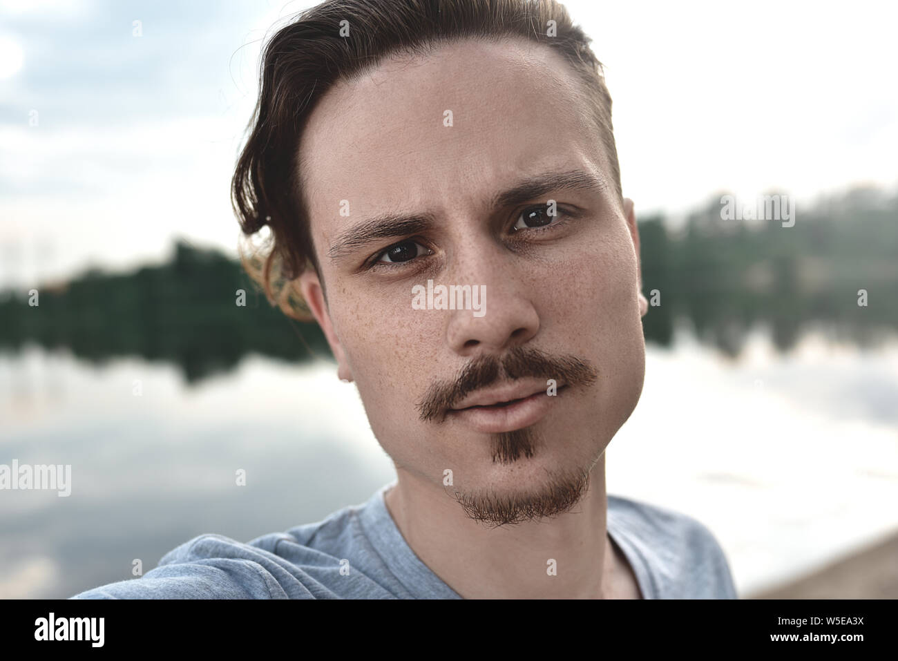 Handsome caucasian guy takes a selfie at the beach - people, lifestyle ...
