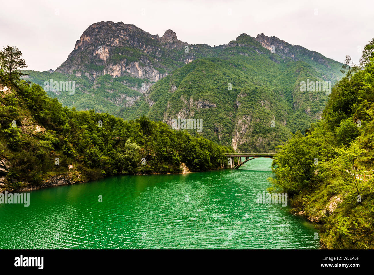 Arched bridge over a side channel in to Lago del Mis, near Belluno ...