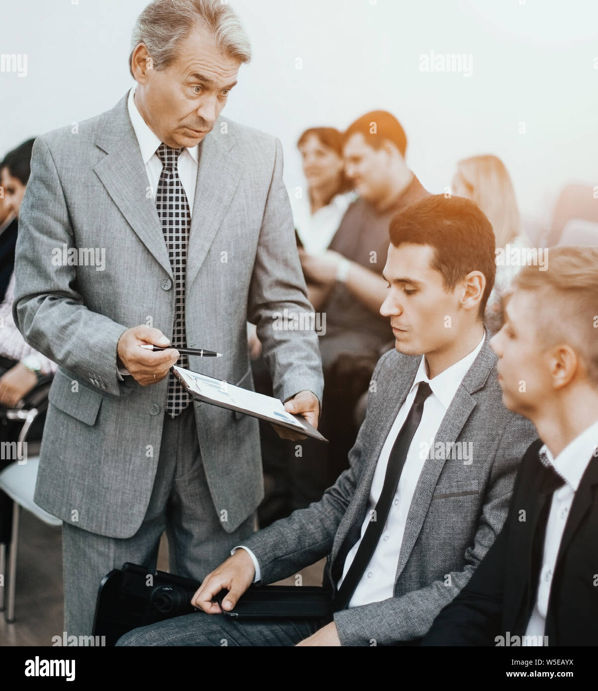 Business meeting - manager discussing work with his colleagues in the ...