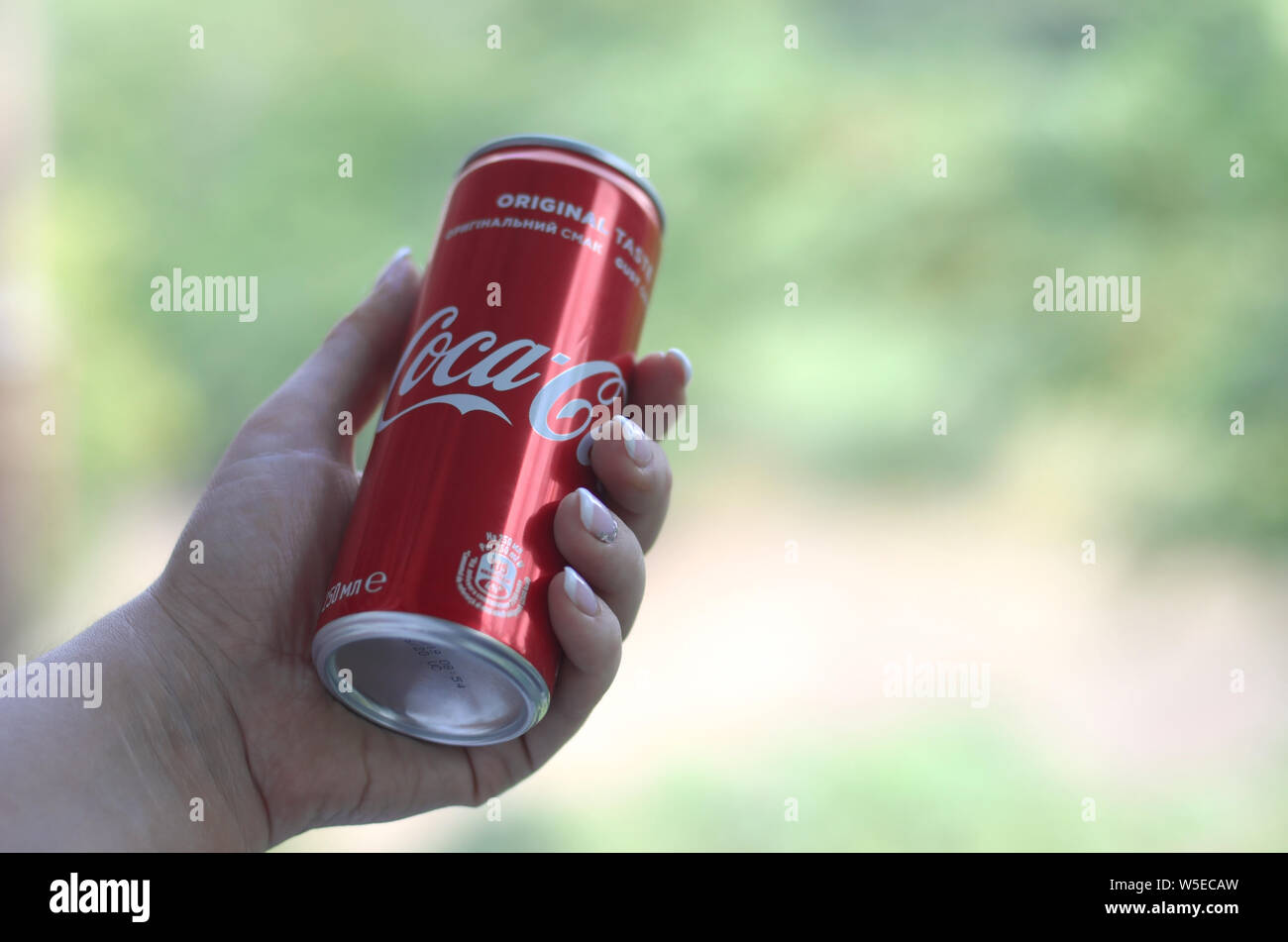 KHARKIV, UKRAINE - JULY 15, 2019: Caucasian woman holds red Coca-Cola ...