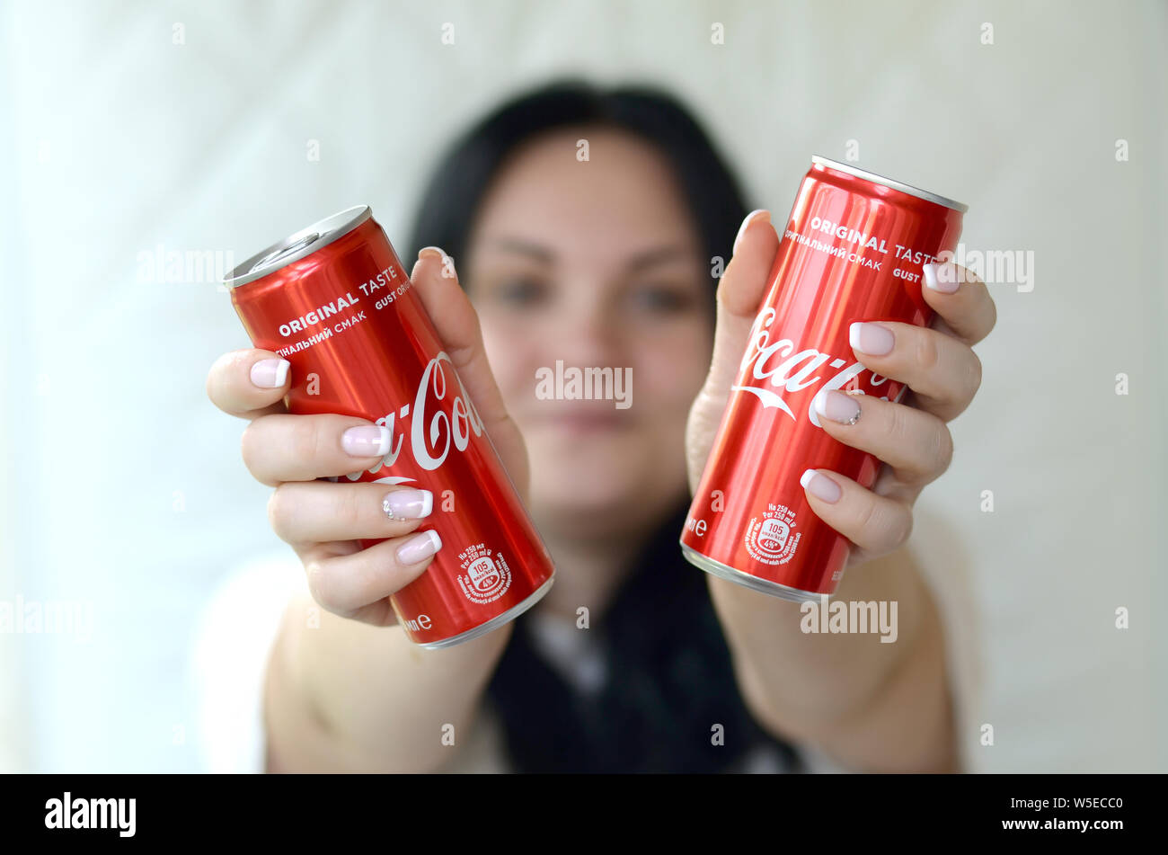 KHARKIV, UKRAINE - JULY 15, 2019: Happy woman holding two non-alcoholic ...