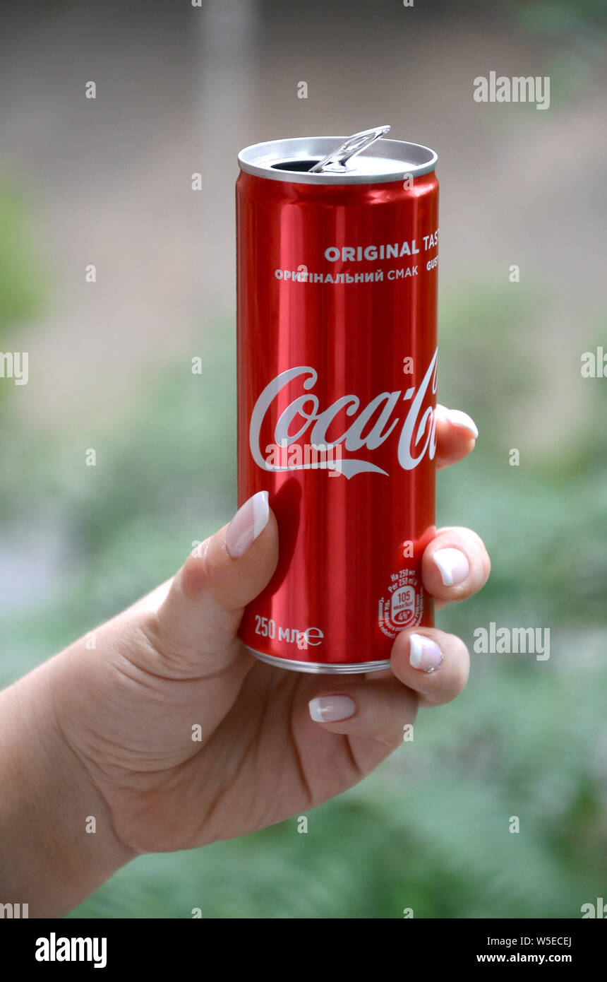 KHARKIV, UKRAINE - JULY 15, 2019: Caucasian woman holds red Coca-Cola ...