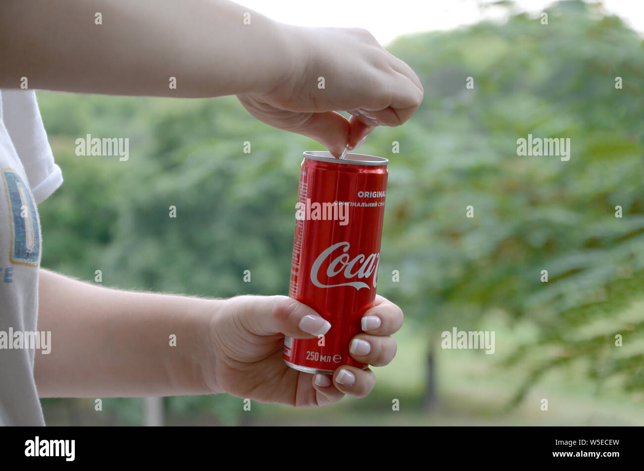 KHARKIV, UKRAINE - JULY 15, 2019: Caucasian woman holds red Coca-Cola ...