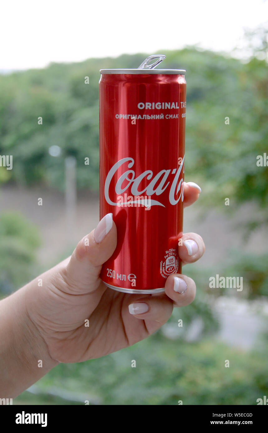 KHARKIV, UKRAINE - JULY 15, 2019: Caucasian woman holds red Coca-Cola ...