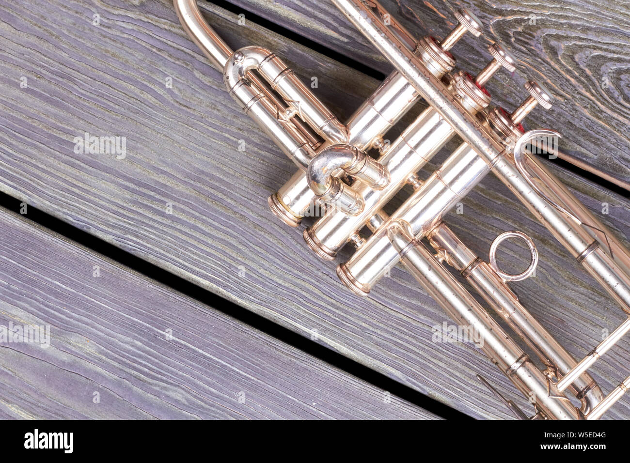 Old trumpet on wooden background Stock Photo - Alamy