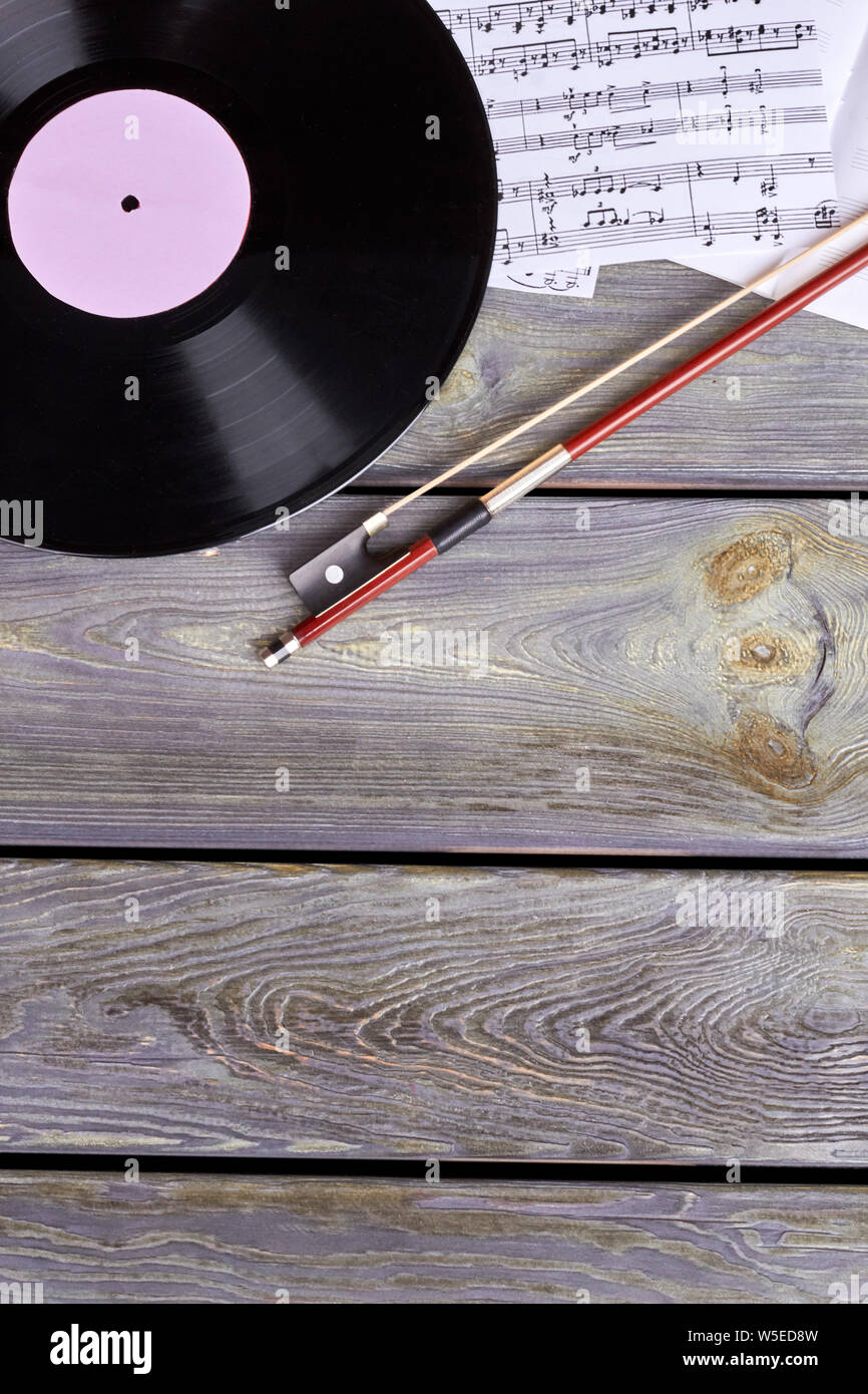 Vinyl record and musical notes sheets Stock Photo - Alamy