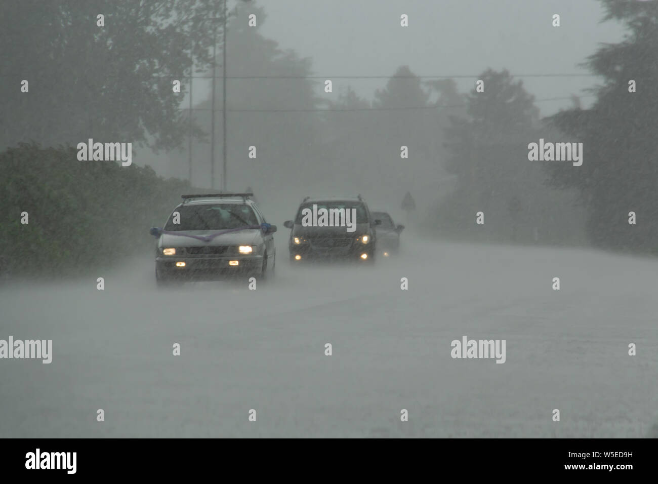 The strong storm with heavy rain on the road with poor visibility of ...