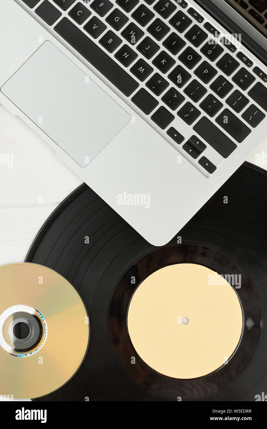 Laptop, vinyl record and compact disc Stock Photo - Alamy