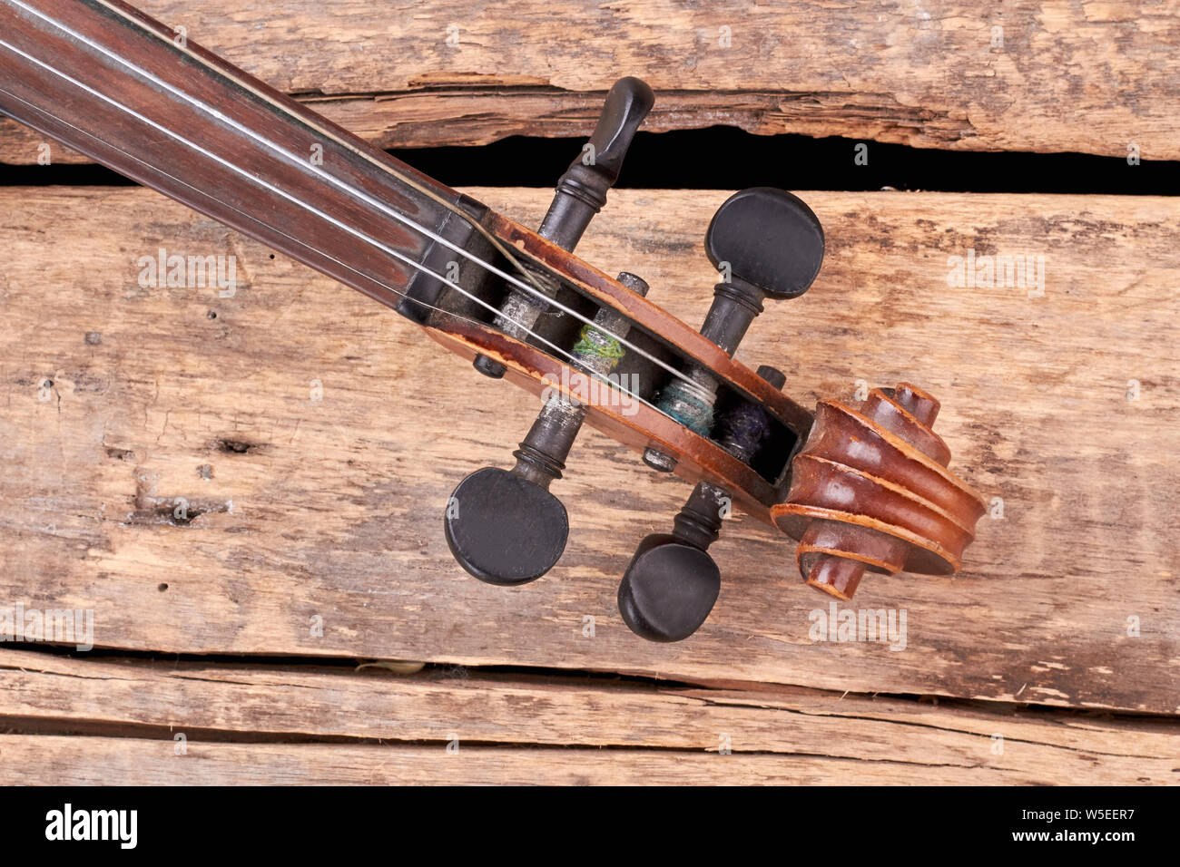 Scroll of the violin on wooden boards Stock Photo - Alamy