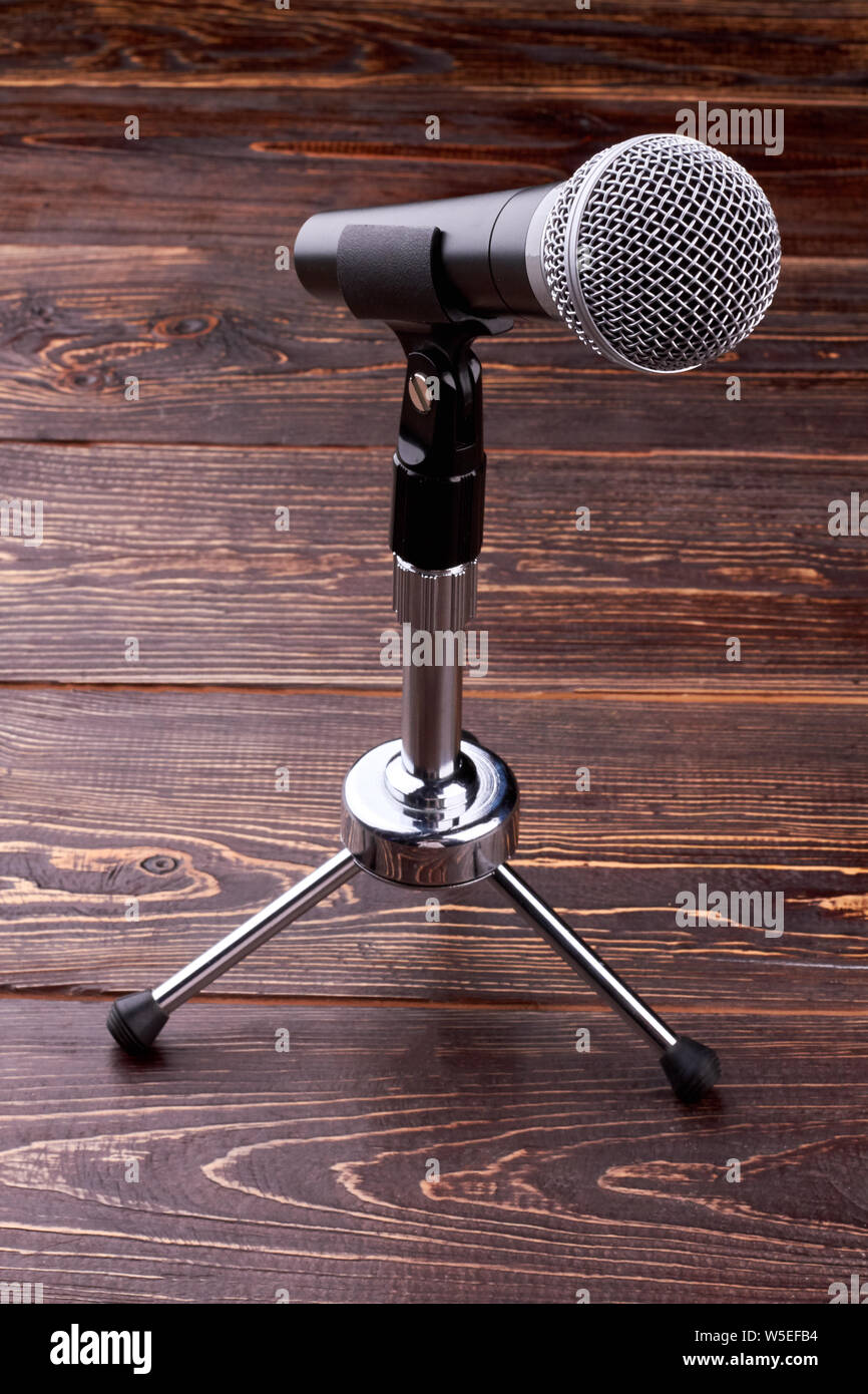 Microphone on brown wooden background Stock Photo - Alamy