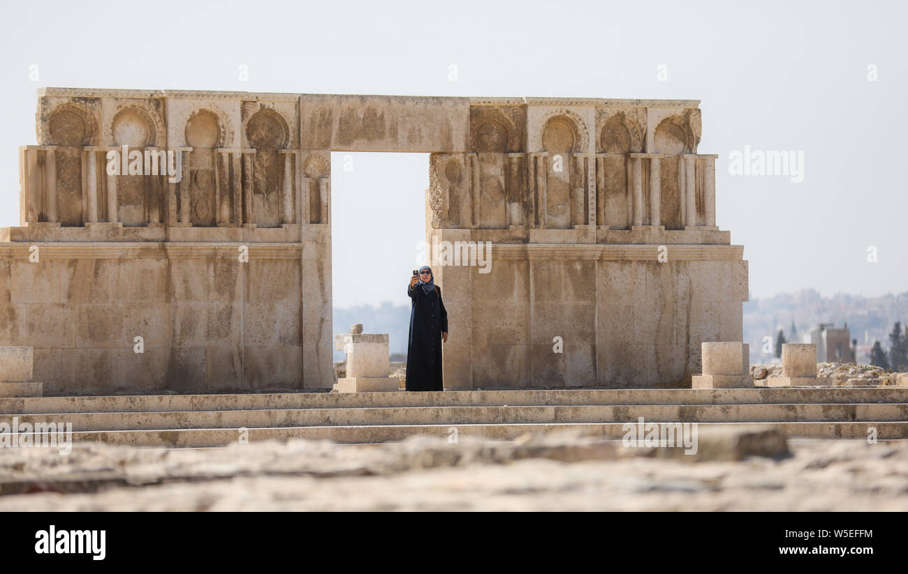 muslim woman in traditional dress takes a selfie on the citadel in ...
