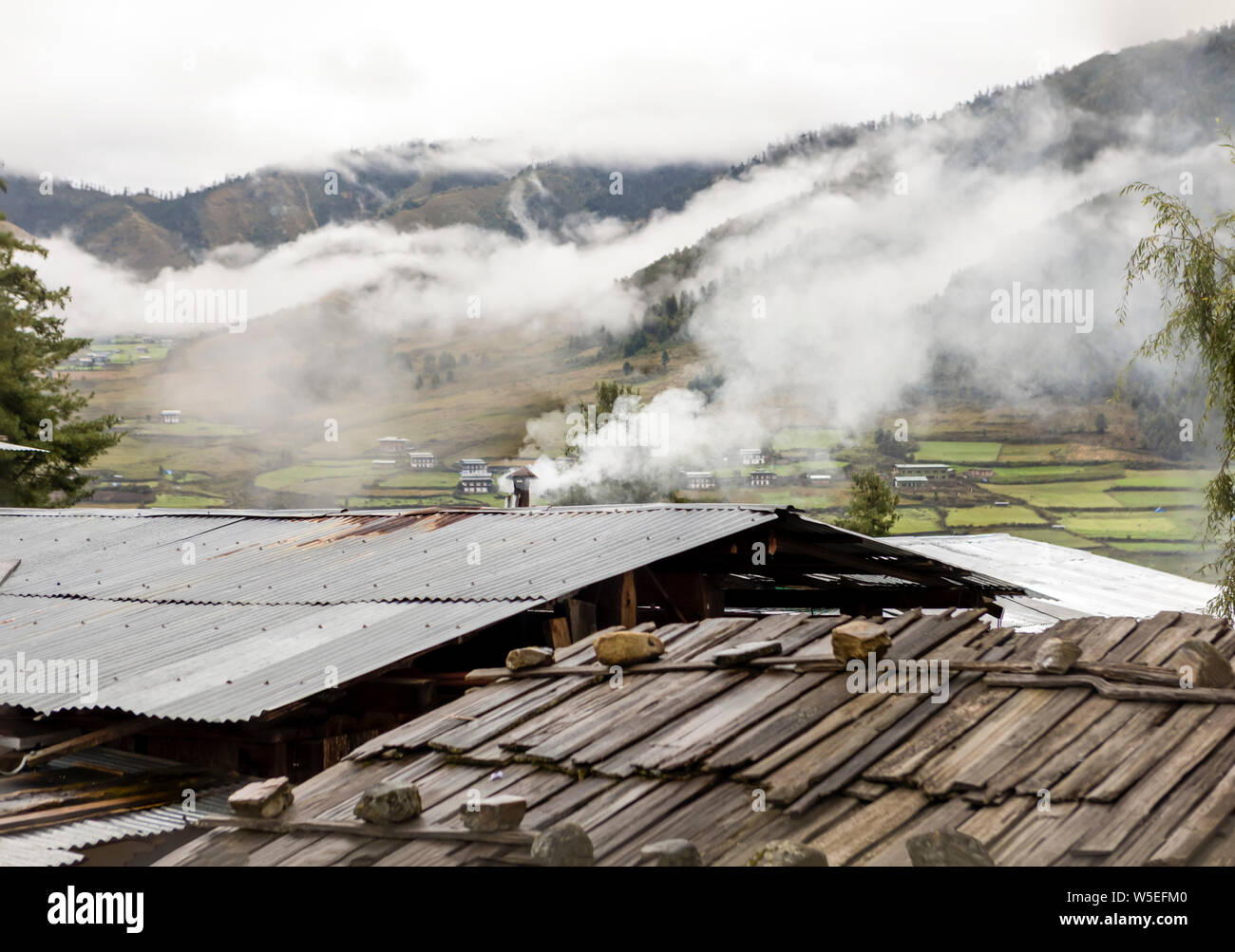 View of Phobjikha Valley, Bhutan, over the rooves of farm buildings ...