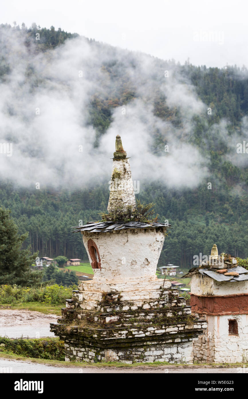 A Buddhist prayer wall and chorten or stupa at the bottom of the road ...