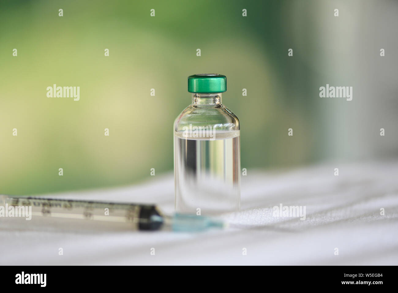 Medicine bottles glass and syringe injection needle on the table ...