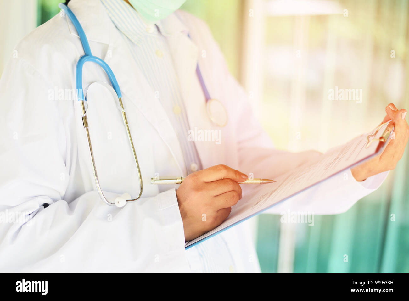 doctor woman asian note on medical record - medical examination report ...