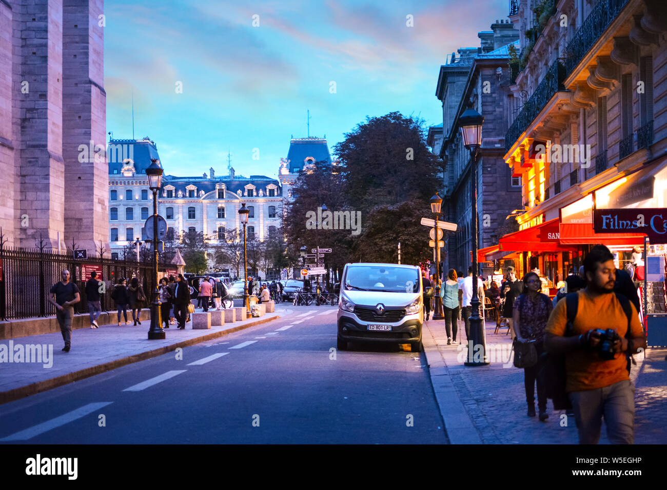 Tourists and locals enjoy an evening out at the shops and cafes on the ...
