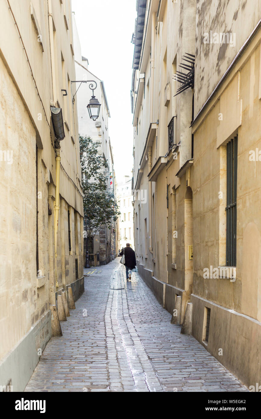 Narrow street in the Marais, Paris, France, with one pedestrian in ...