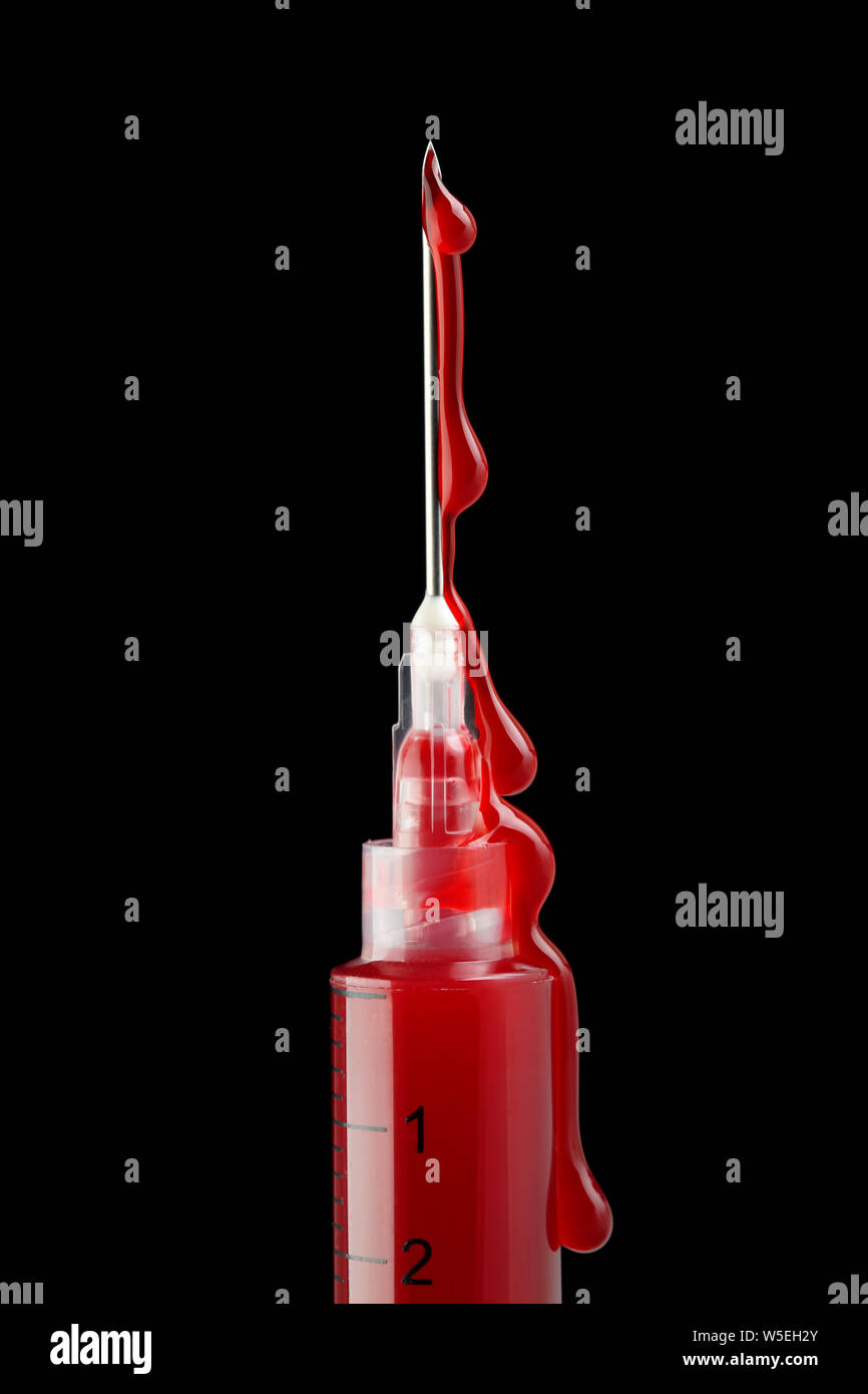 Syringe filled with blood and dripping from the needle - isolated on ...