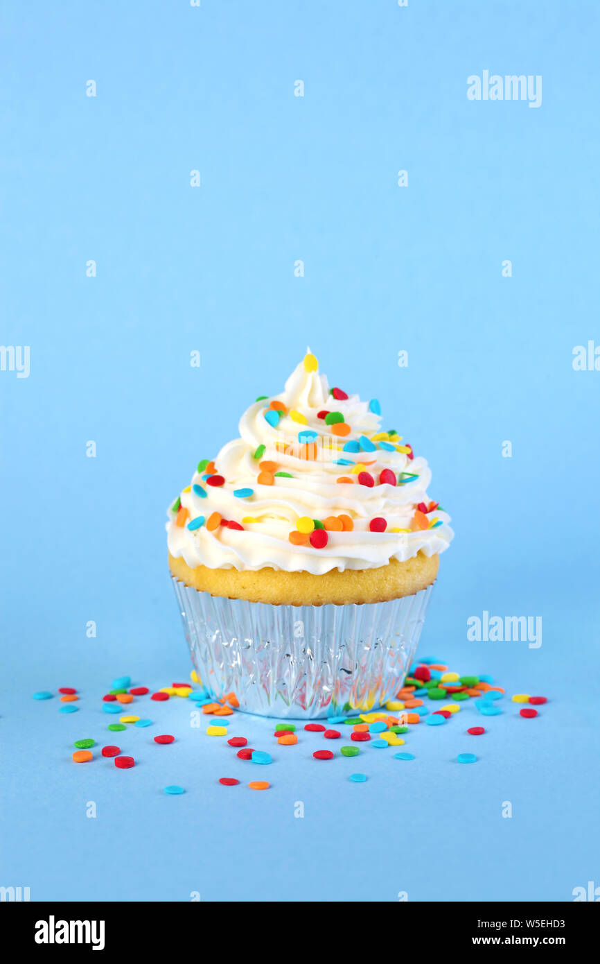 Single iced cupcake with colorful sprinkles Stock Photo - Alamy