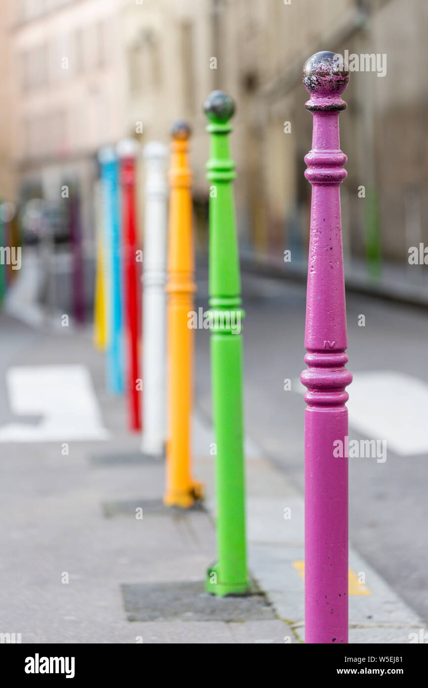 Multicolored bollards on the street in Village Saint Paul, Paris Stock ...