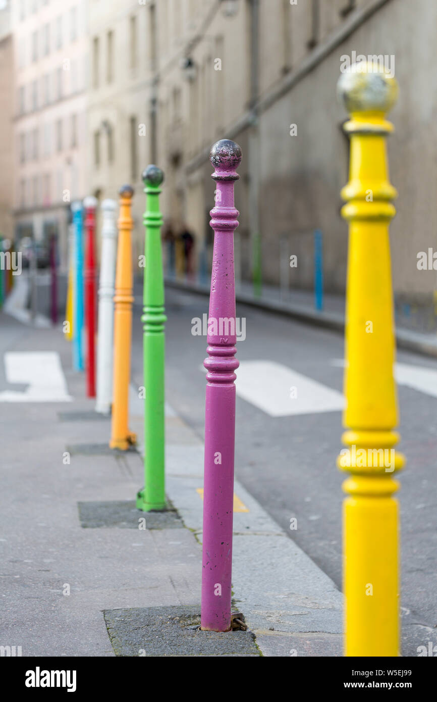 Multicolored bollards on the street in Village Saint Paul, Paris Stock ...