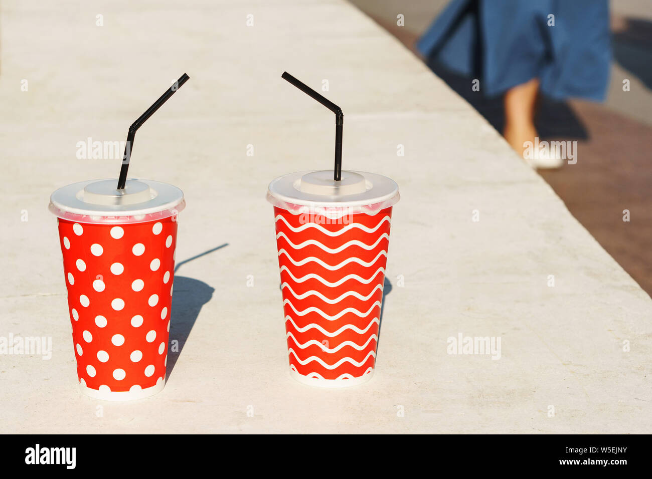 Two cocktails in disposable paper cups. Coffee and lemonade to go take ...