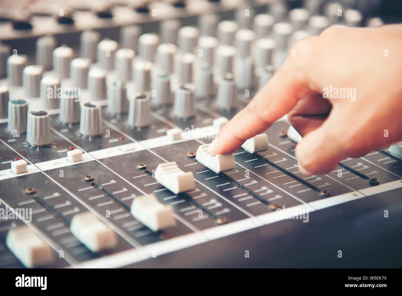 Hands of sound engineer working on recording studio mixer. Expert ...