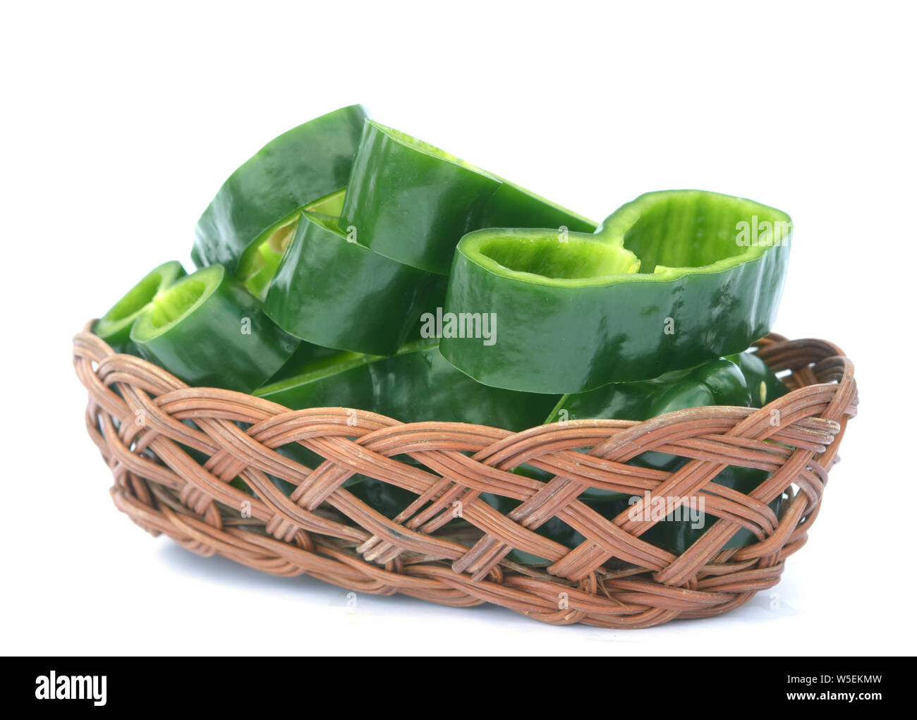 sliced poblano pepper on bamboo basket on white background Stock Photo ...
