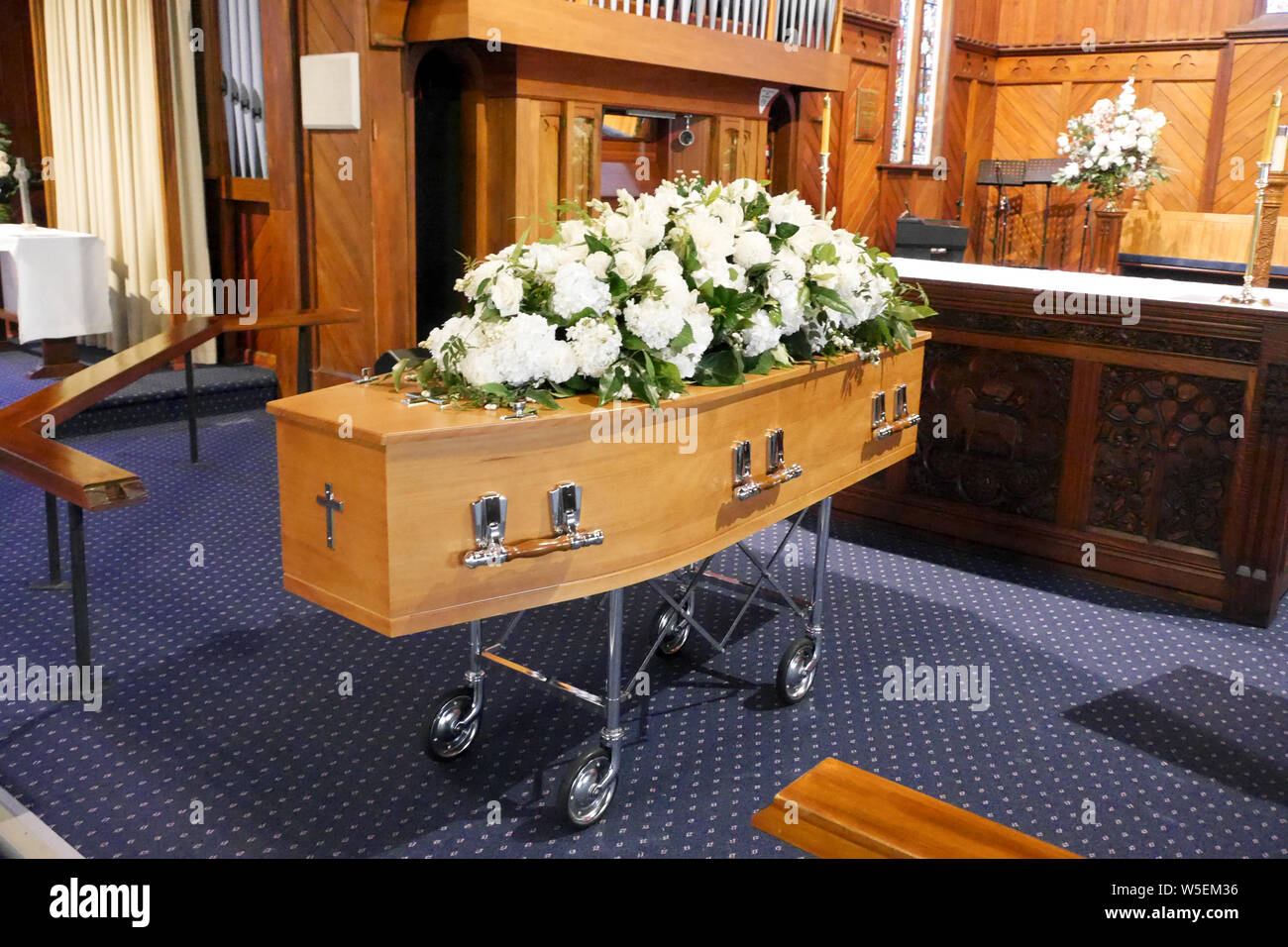 closeup shot of a funeral casket in a hearse or chapel or burial at ...