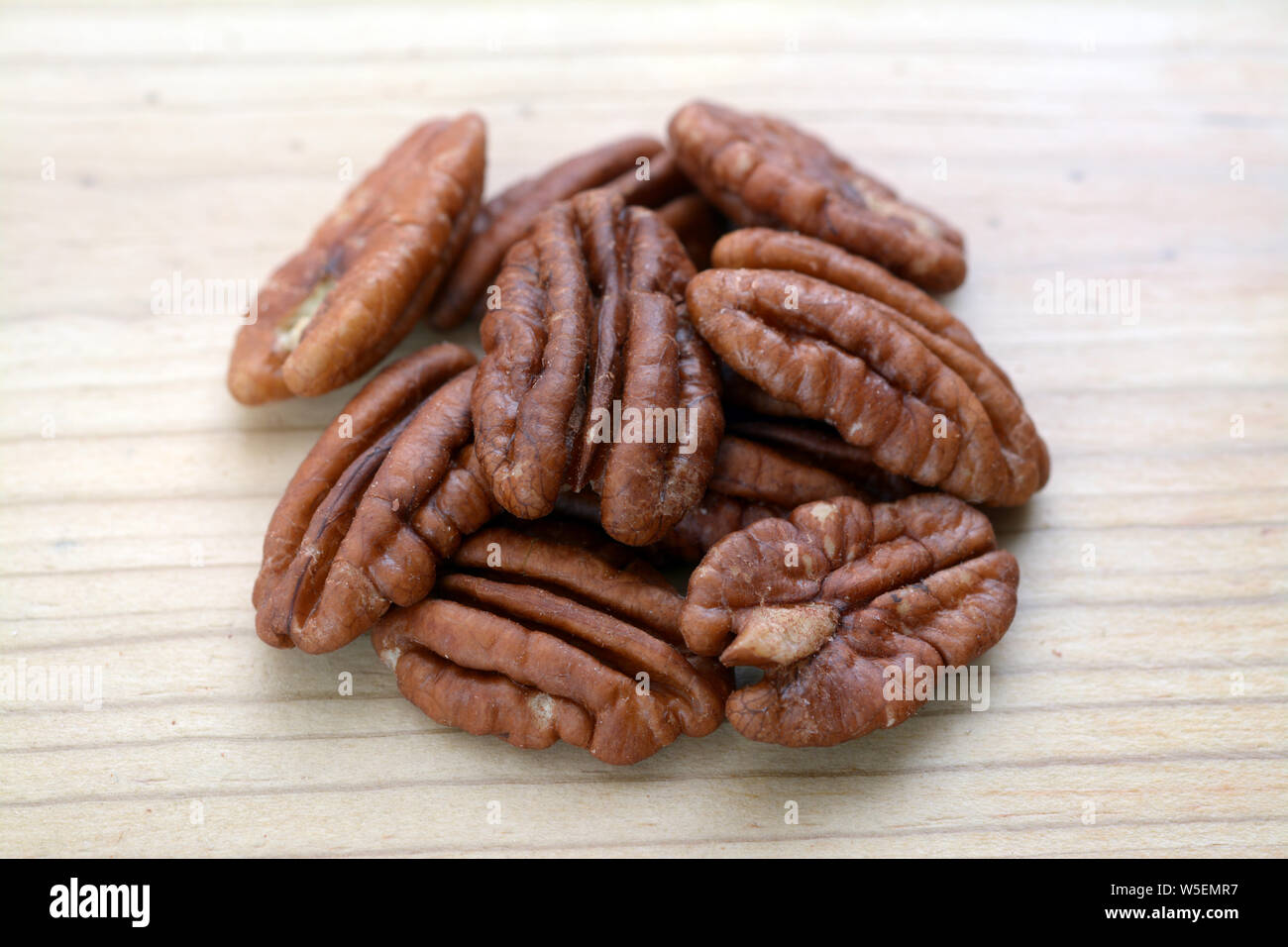 a group of pecan halves on wooden flat Stock Photo - Alamy