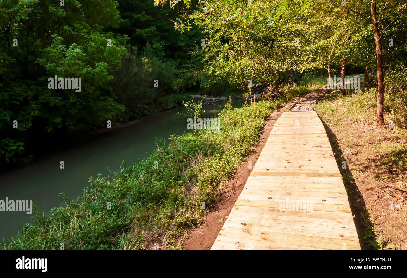 A wooden walkway along Nine Mile Run in Frick Park in Pittsburgh ...