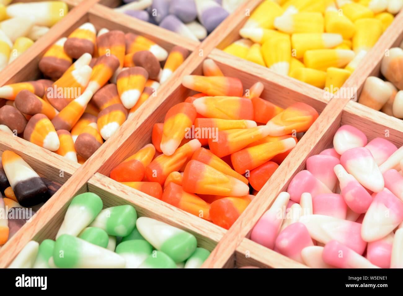 a lot of tooth corn candies in wooden case for background Stock Photo ...